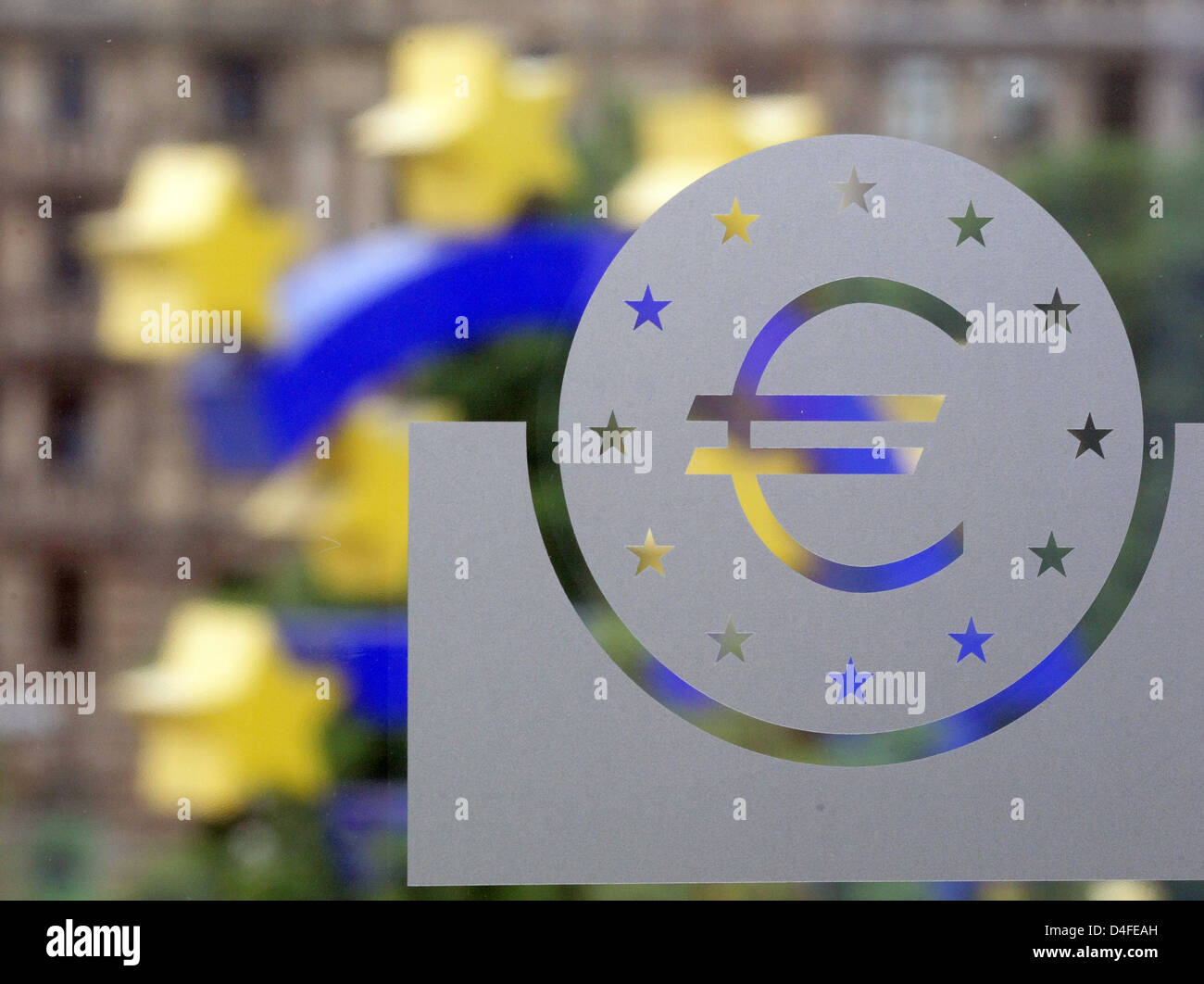 The picture shows the Euro symbol on a window pane at the European ...