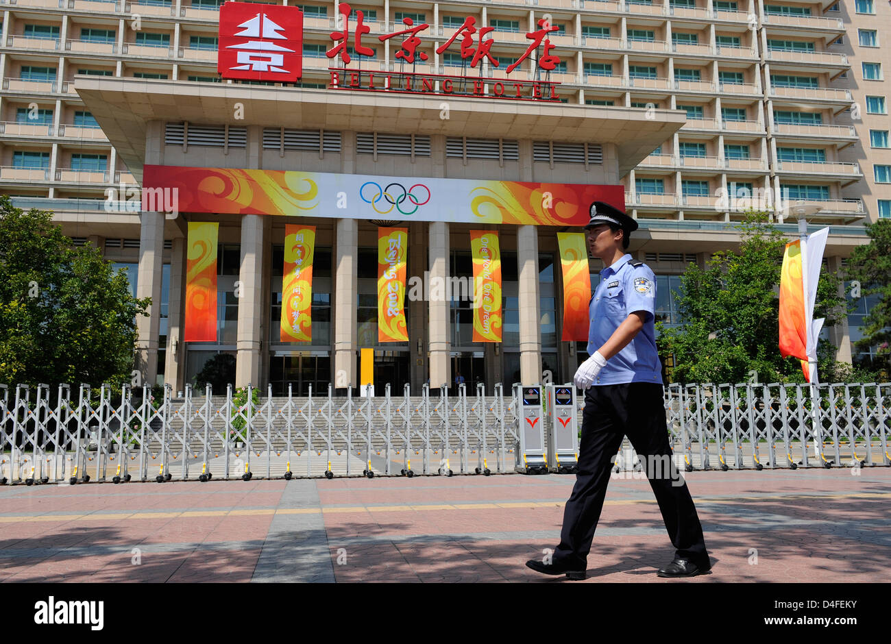 A police officer patrols in front of the hotel, where the Executive ...