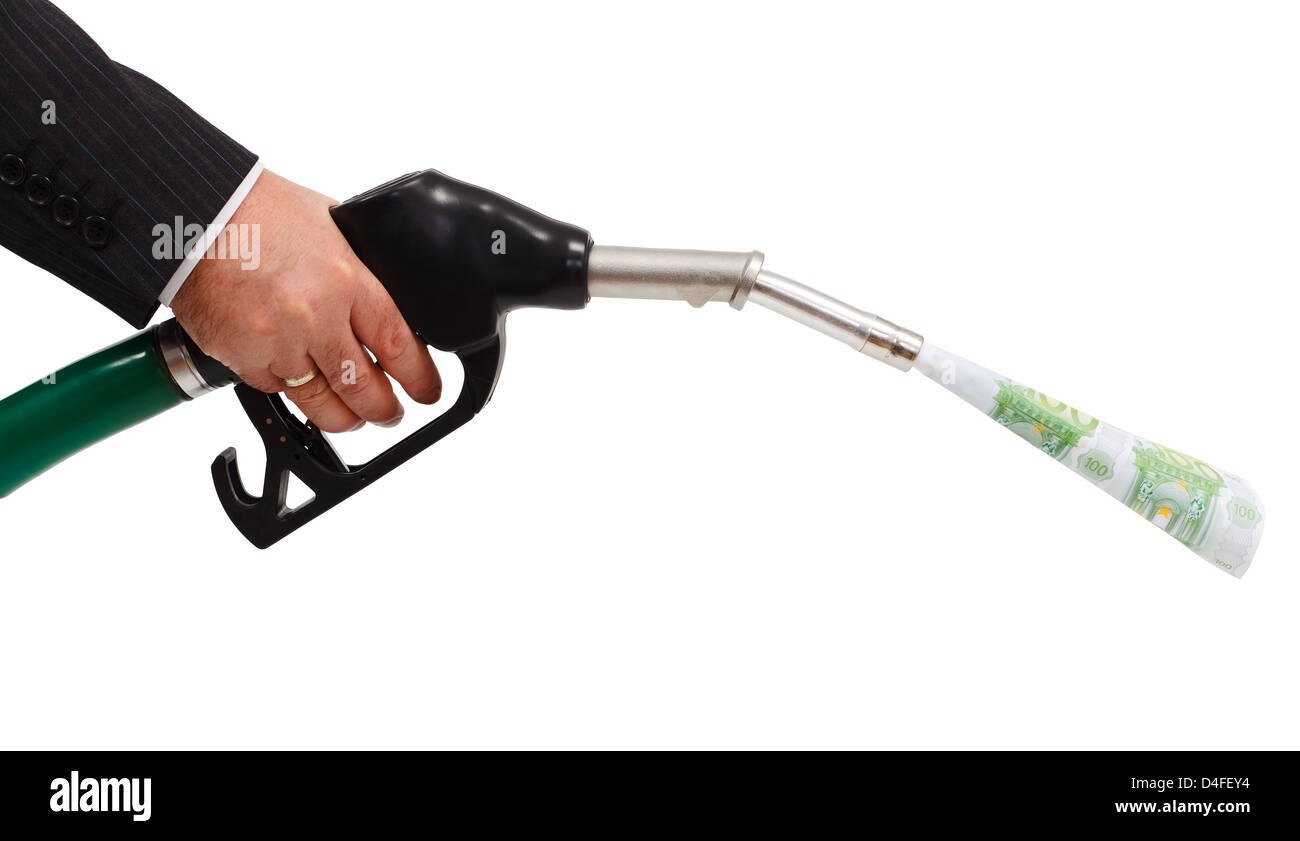 Hand holding gas nozzle, money pouring from pipe Stock Photo - Alamy
