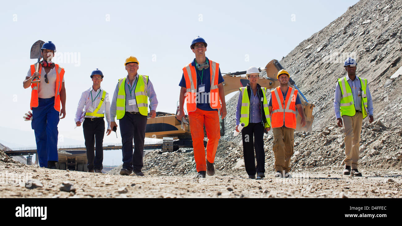 Workers and business people walking in quarry Stock Photo - Alamy