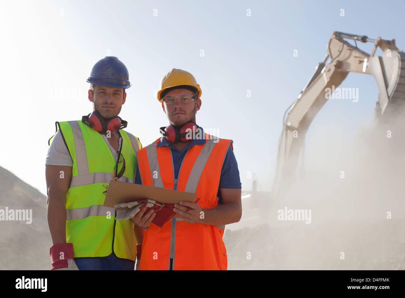 Workers standing in quarry Stock Photo - Alamy