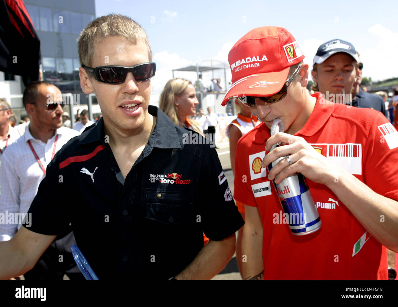Finnish Formula One driver Kimi Raikkonen of Ferrari (R) and German ...