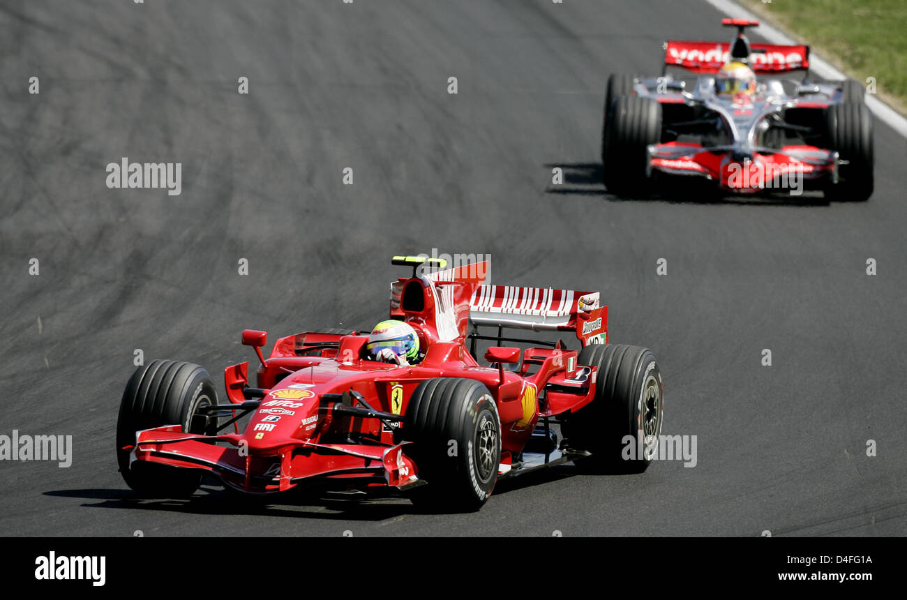 Brazilian Formula One driver Felipe Massa of Ferrari (L) steers his car ...