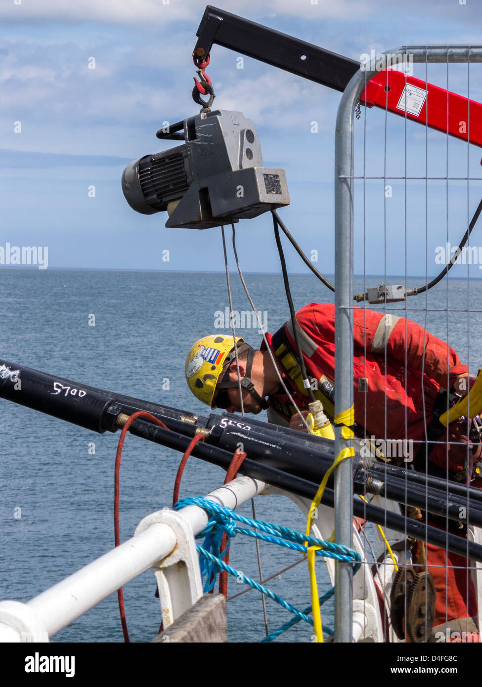 Engineer looking over railing's on pier renovation work with ...