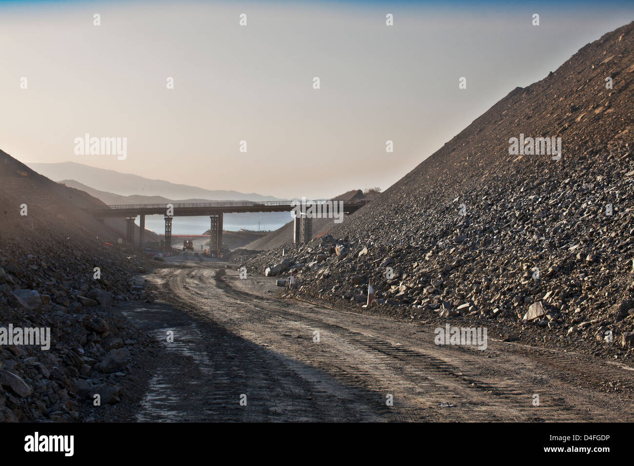 Bridge spanning road in quarry Stock Photo - Alamy
