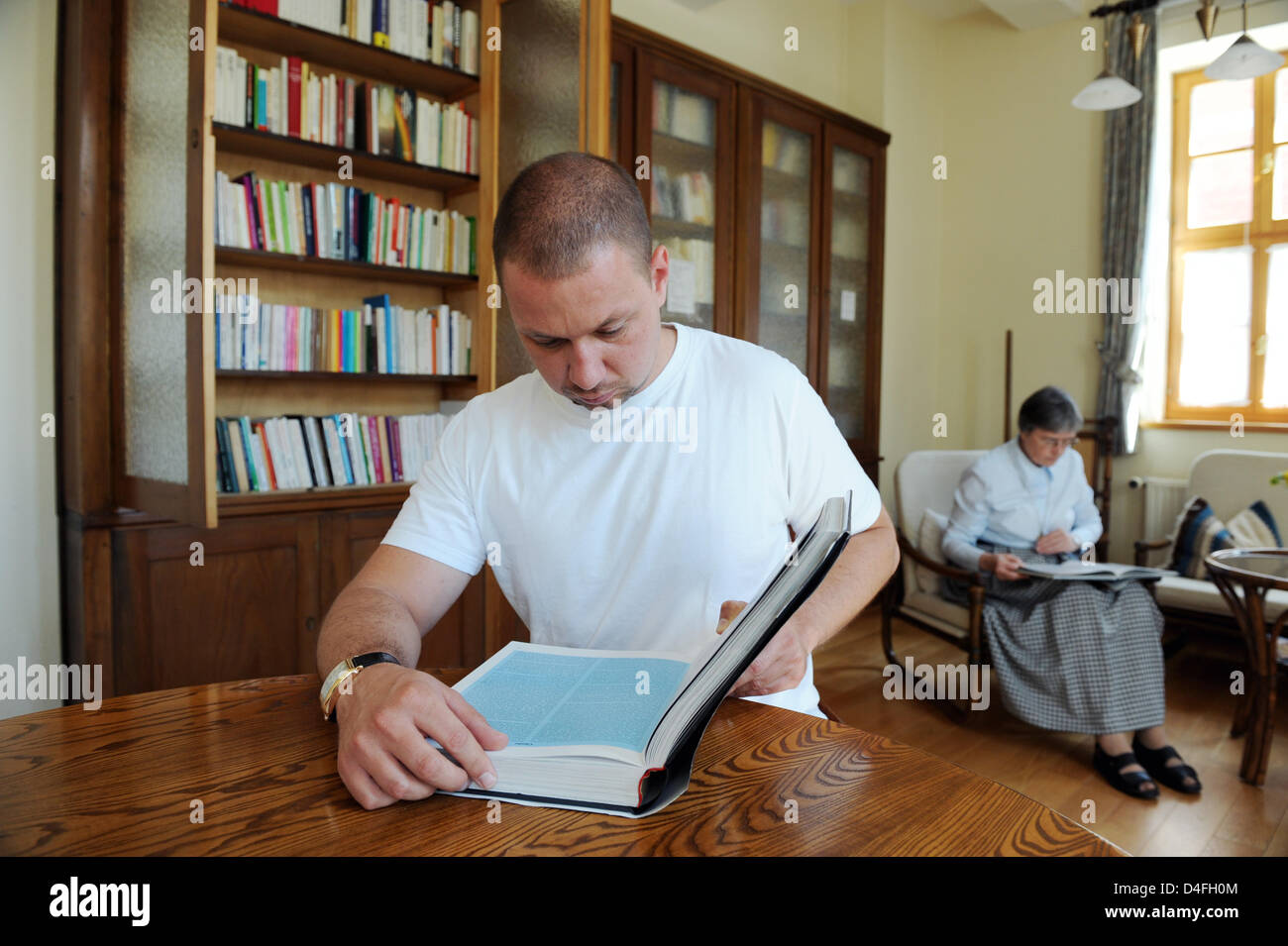 A stressed out manager reads the bible in the library of the Ursuline ...