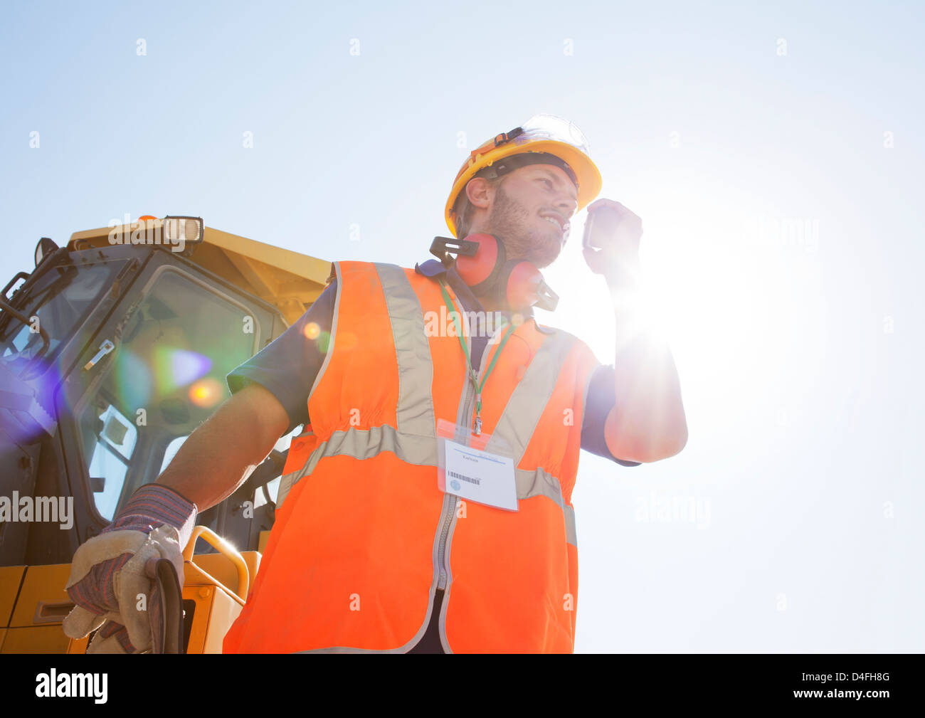 Worker using walkie-talkie on site Stock Photo - Alamy