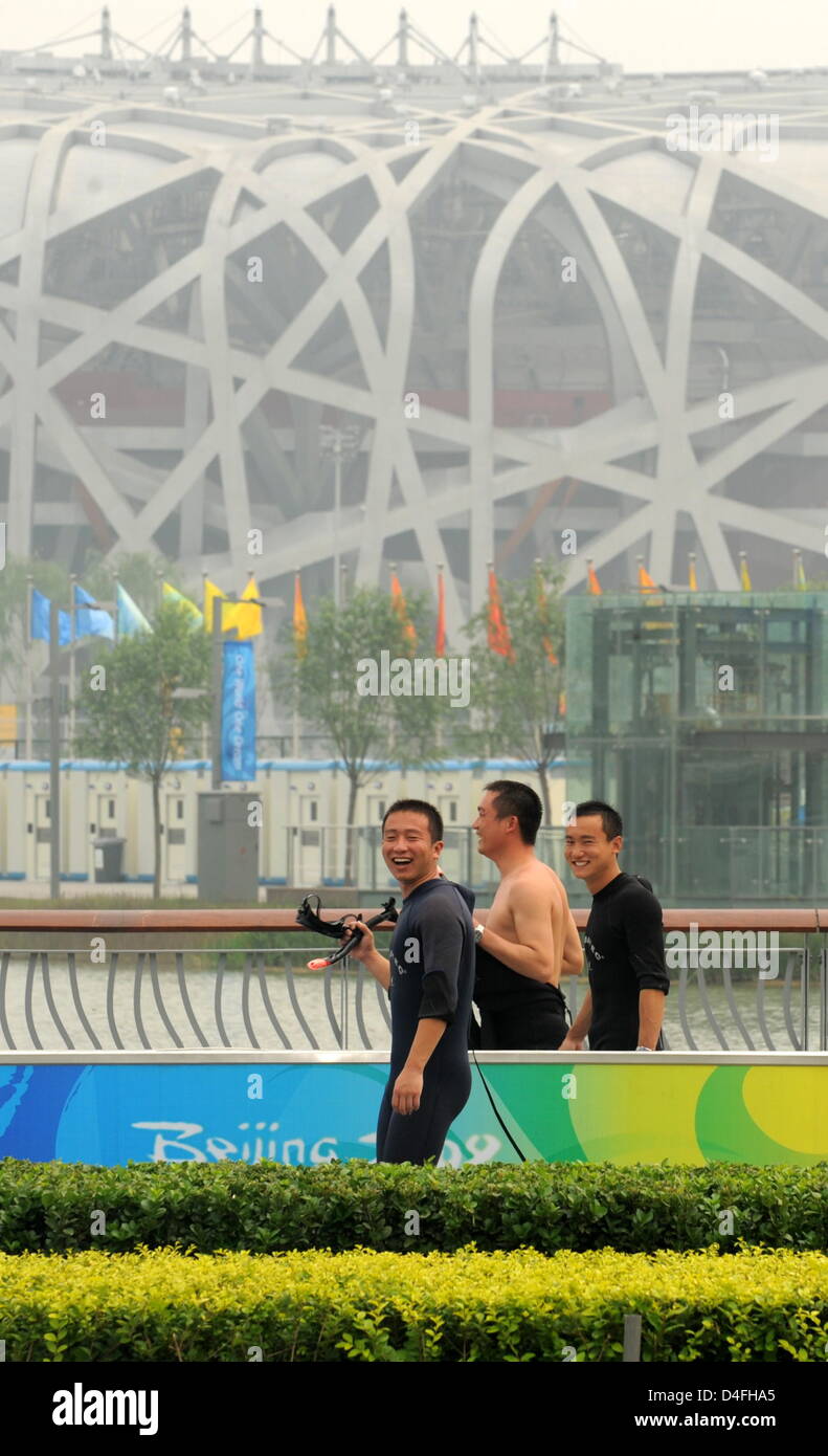 Three frogmen walk along the National Stadium ahead of the Beijing 2008 ...