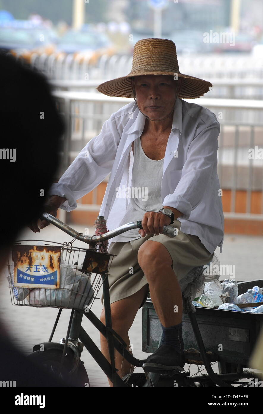 Old chinese man riding bicycle hi-res stock photography and images - Alamy