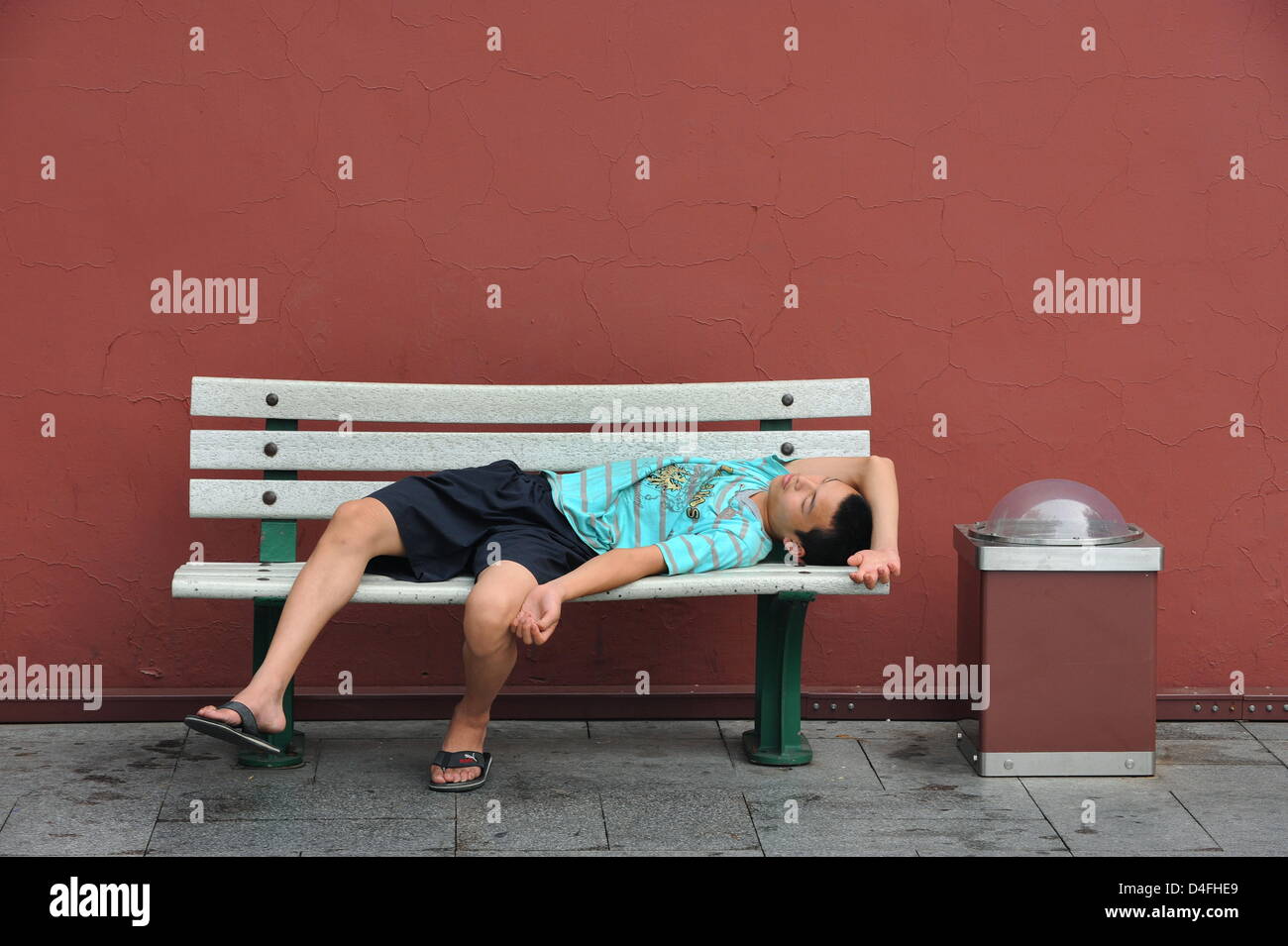 A man rest on a bench in the streets of Beijing, China, 07 August 2008 ...