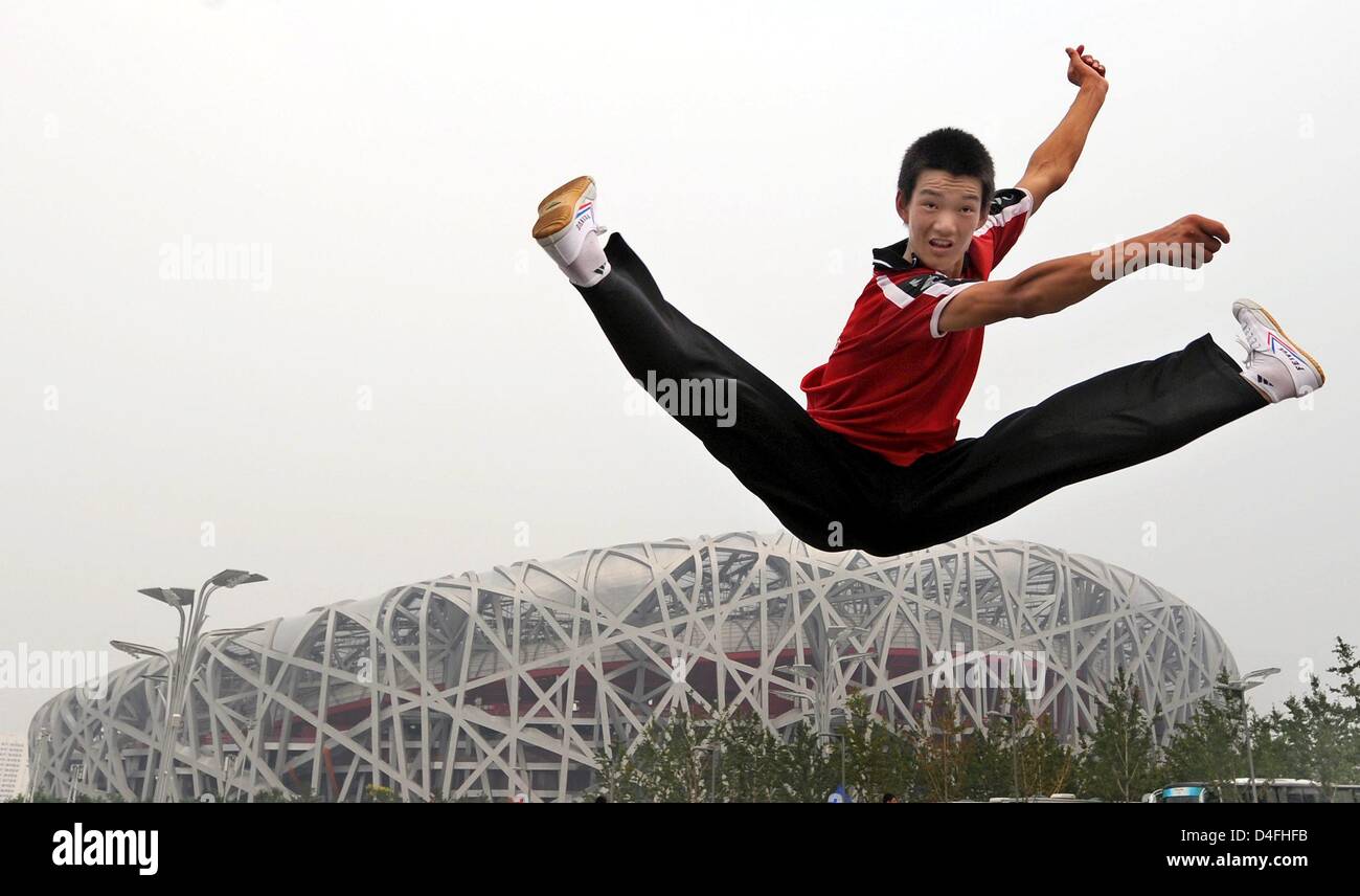 A young chinese assistent jumps in front of the National Stadium prior ...