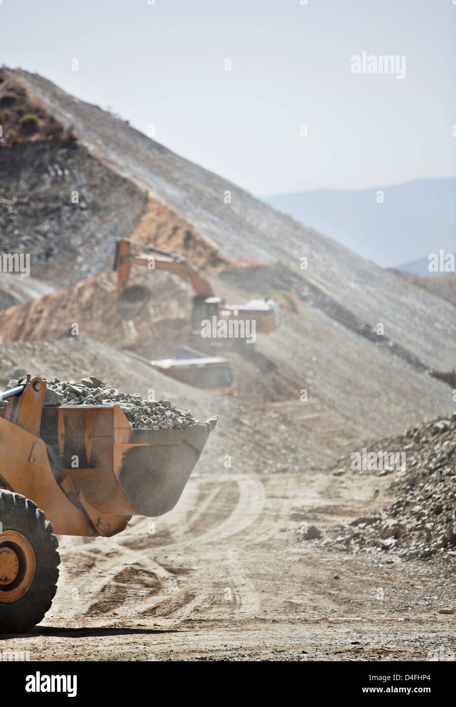 Diggers working in quarry Stock Photo - Alamy