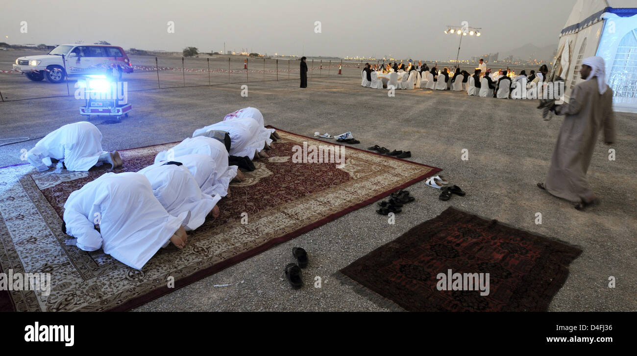 Muslims bow to pray at sunset in the desert near Ras al-Khaimah, United ...