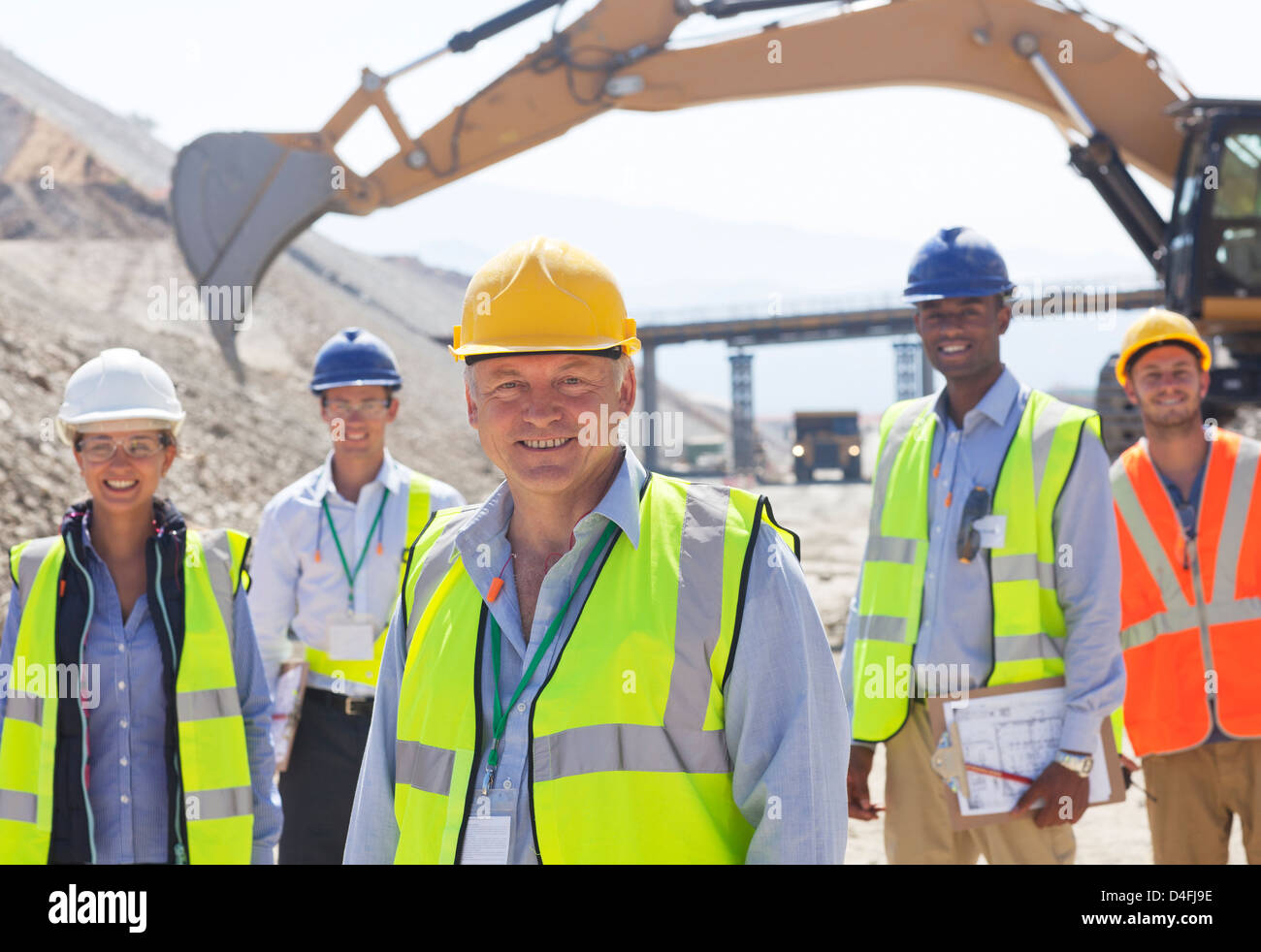 Business people standing in quarry Stock Photo - Alamy