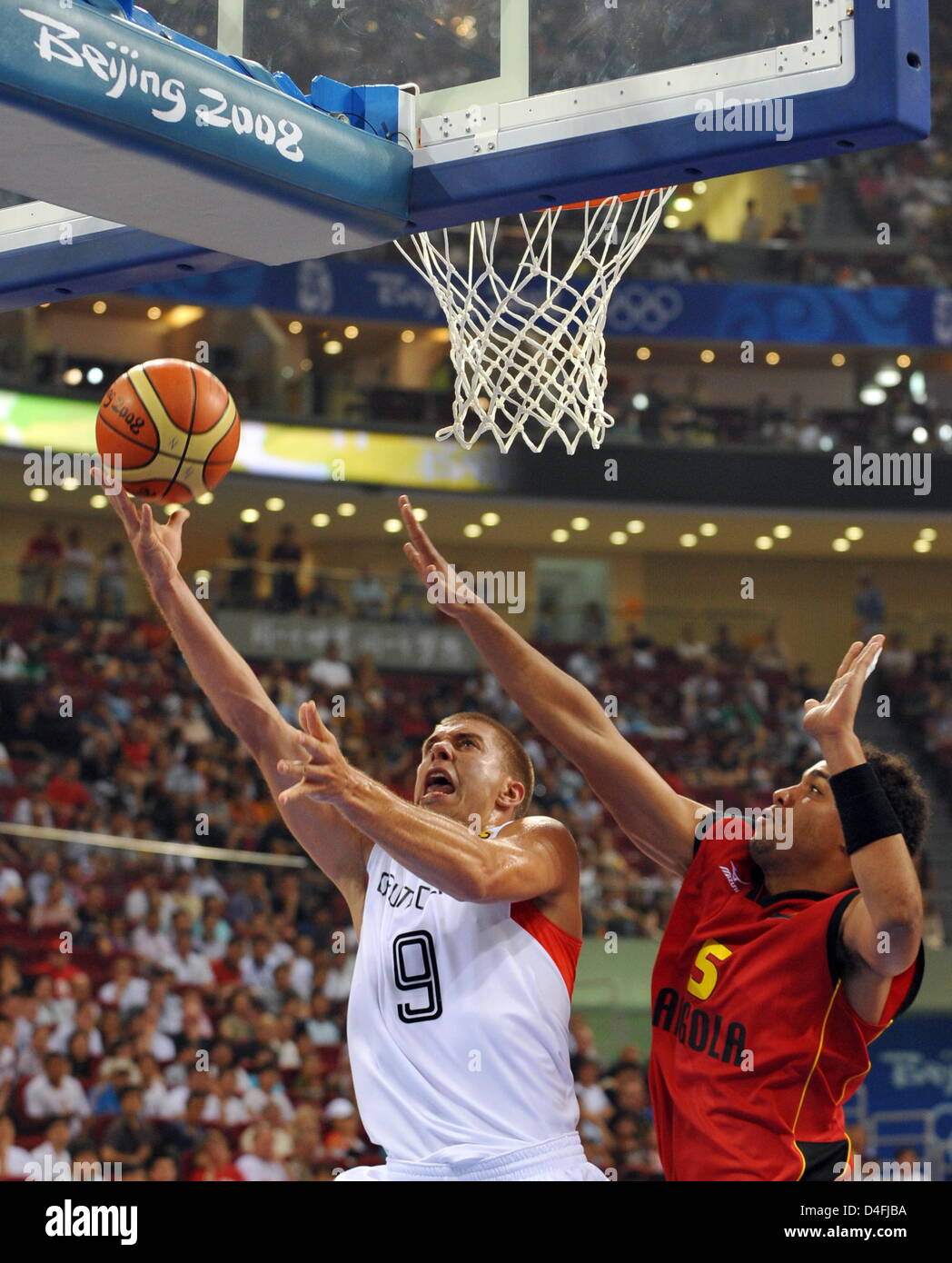 The German basketball player Steffen Hamann (L) vies with Armando Costa ...