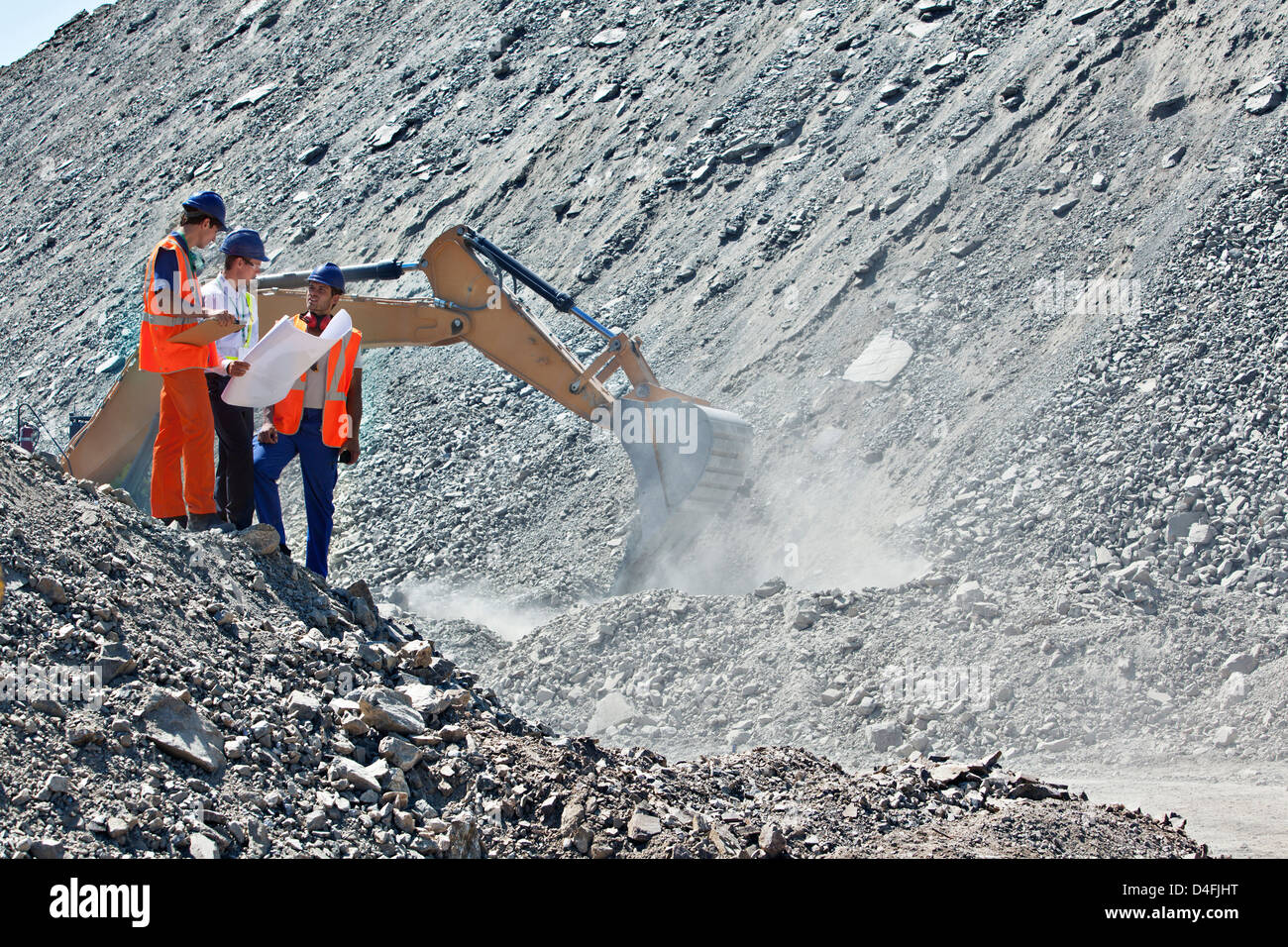 Workers and businessman talking in quarry Stock Photo - Alamy