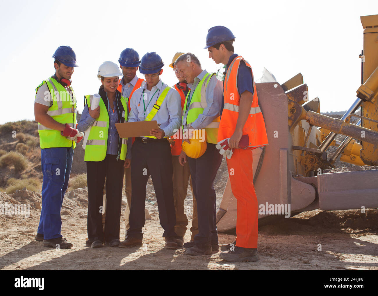 Workers and business people talking on site Stock Photo - Alamy