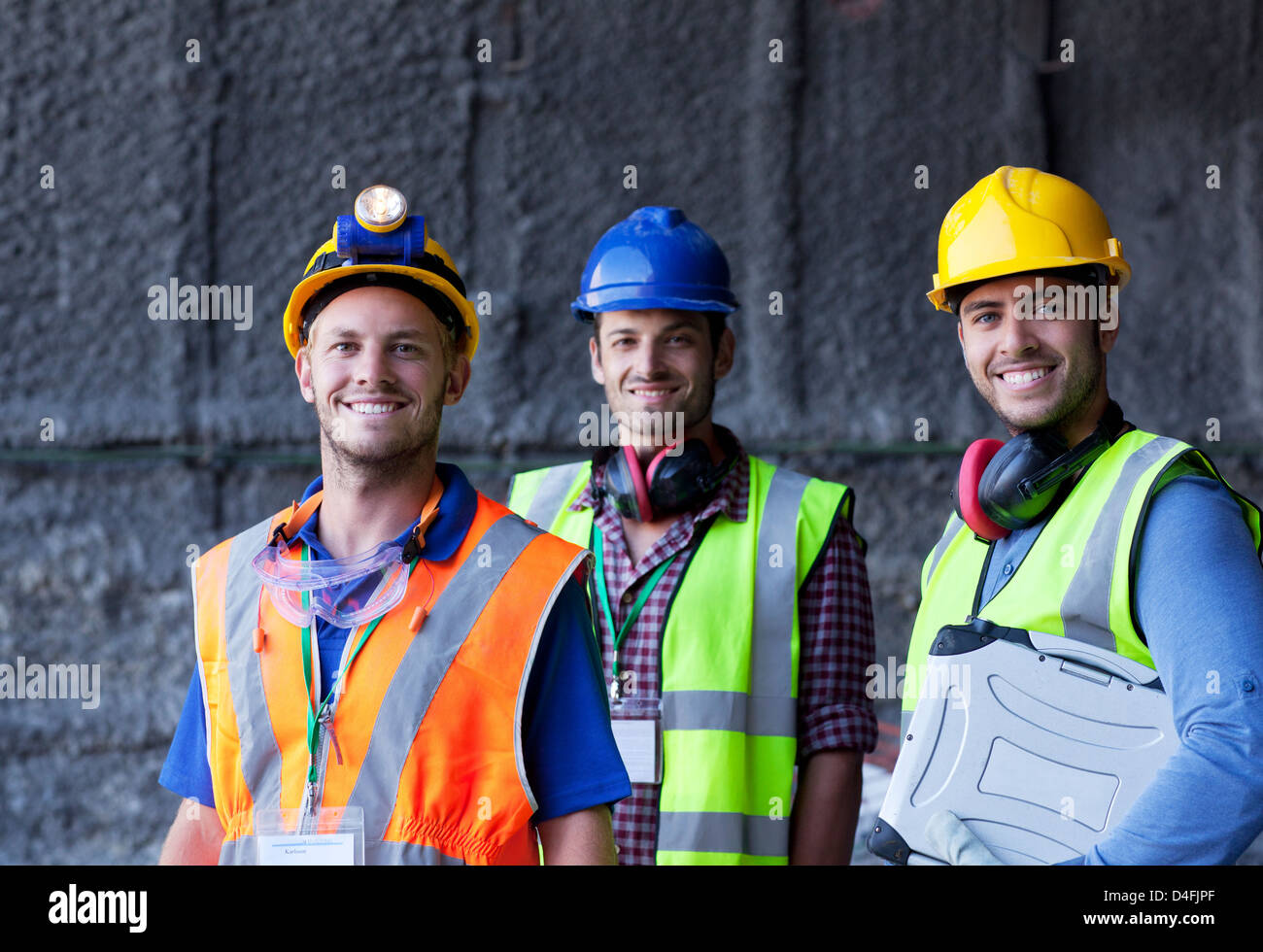 Workers smiling on site Stock Photo - Alamy