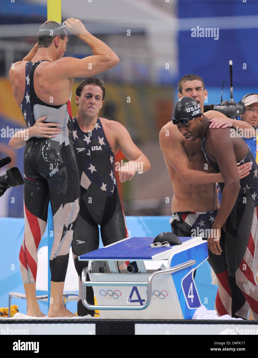 US swimmer Michael Phelps (2nd R) hugs his teammate Cullen Jones while ...