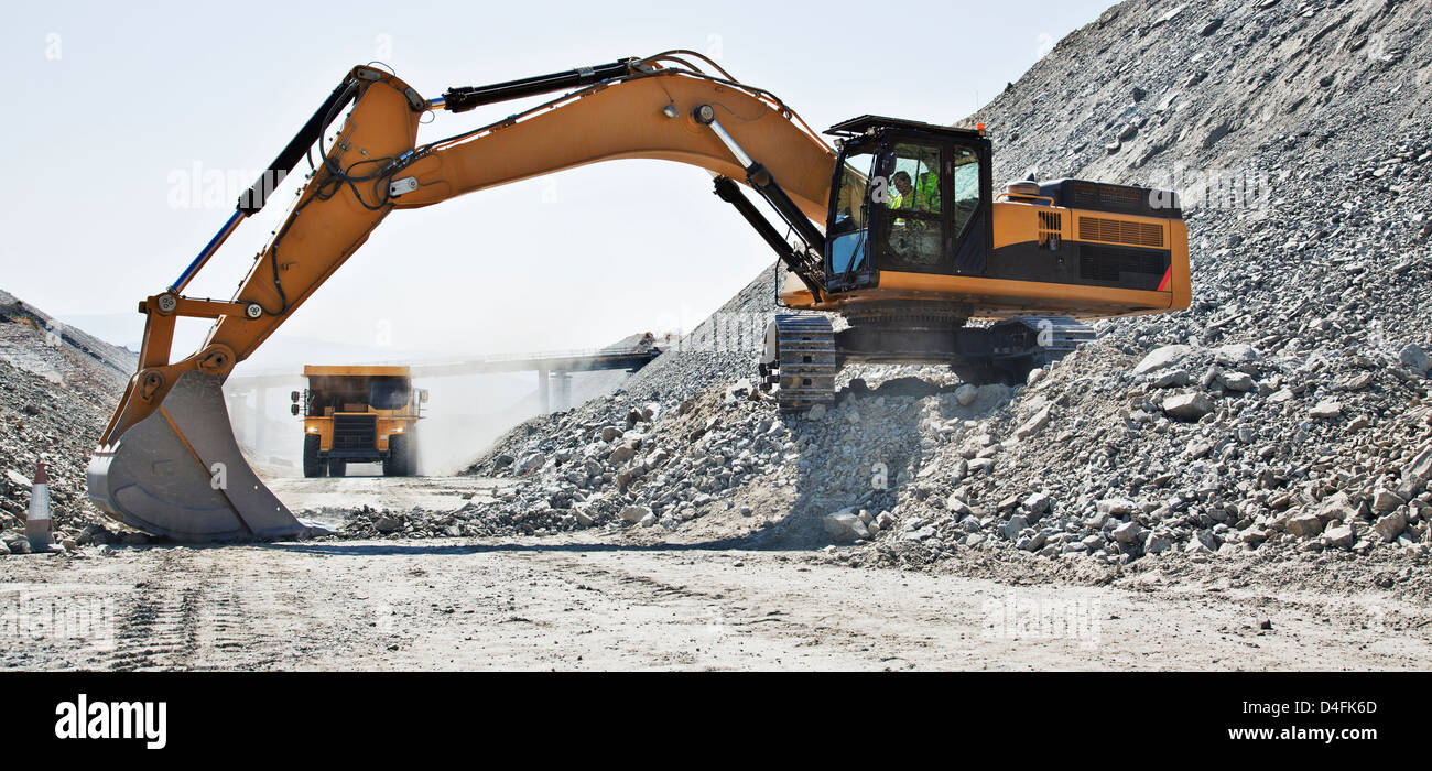 Digger working in quarry Stock Photo - Alamy