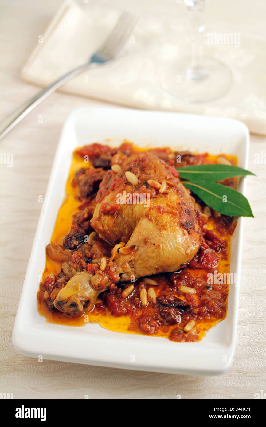 Chicken with raisins and pine nuts. Recipe available Stock Photo - Alamy