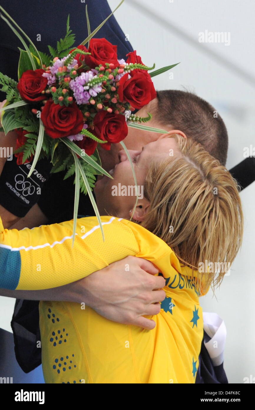 Australian swimmer Lisbeth Trickett gets a kiss from her husband Luke ...