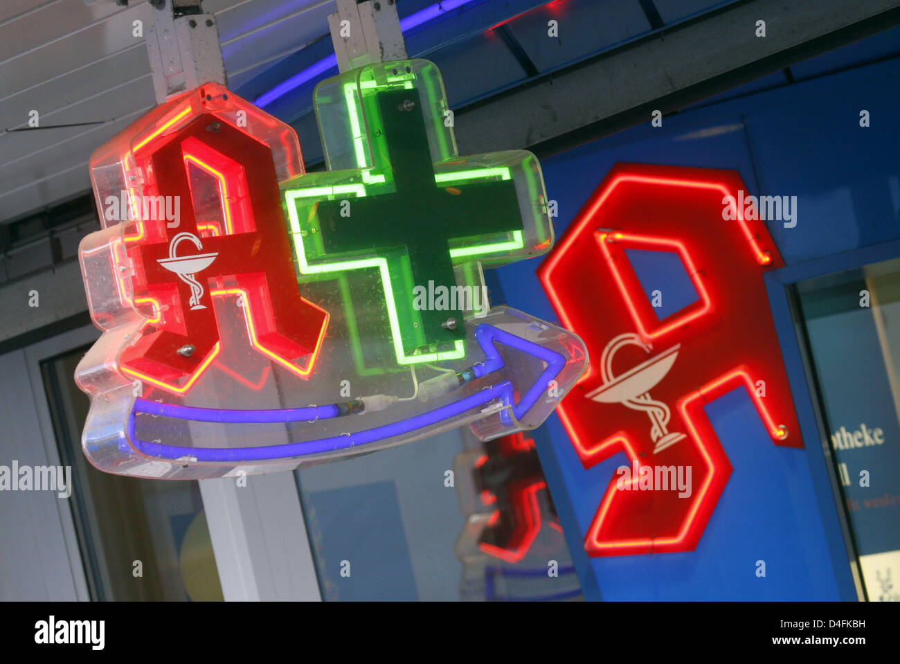 A red pharmacy sign as common in Germany, and a green cross, the ...
