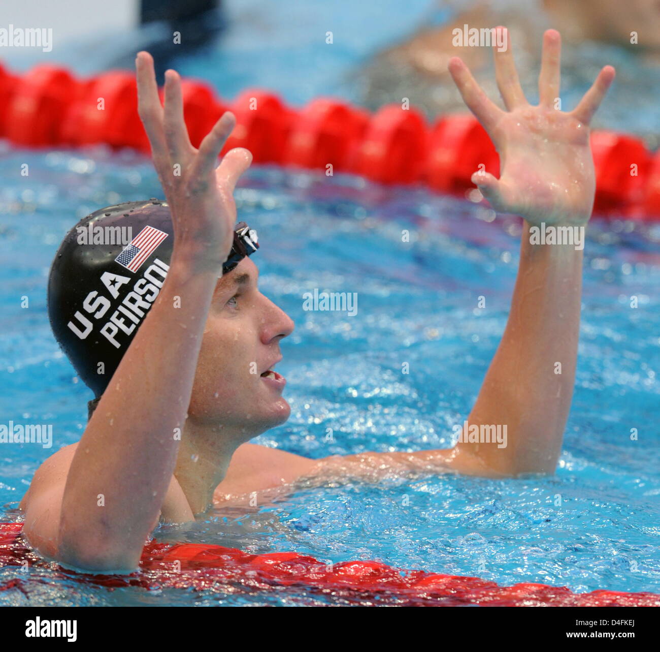 US swimmer Aaron Peirsol jubilates after winning gold and setting a ...