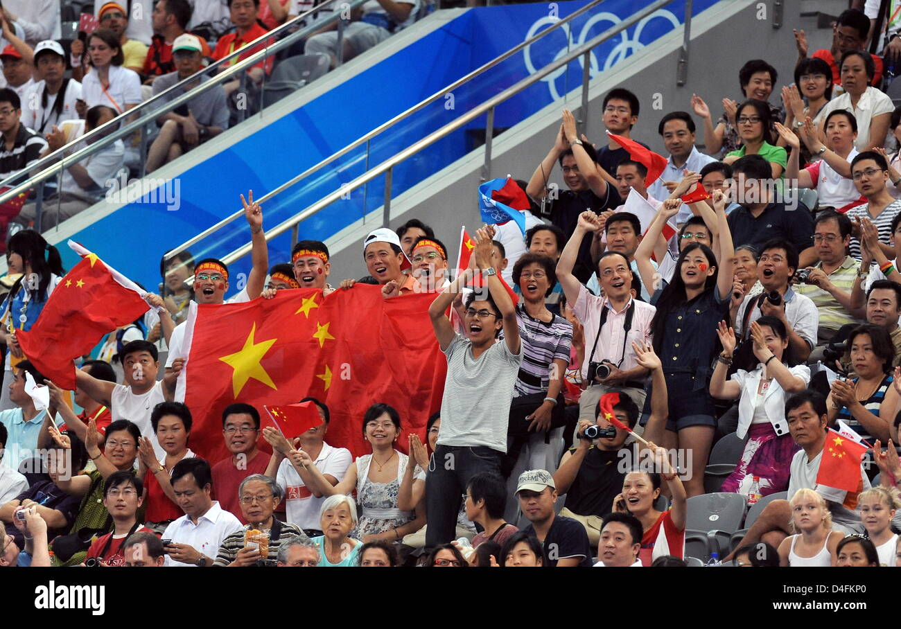 Chinese spectators cheer during the mens team final at artistic ...