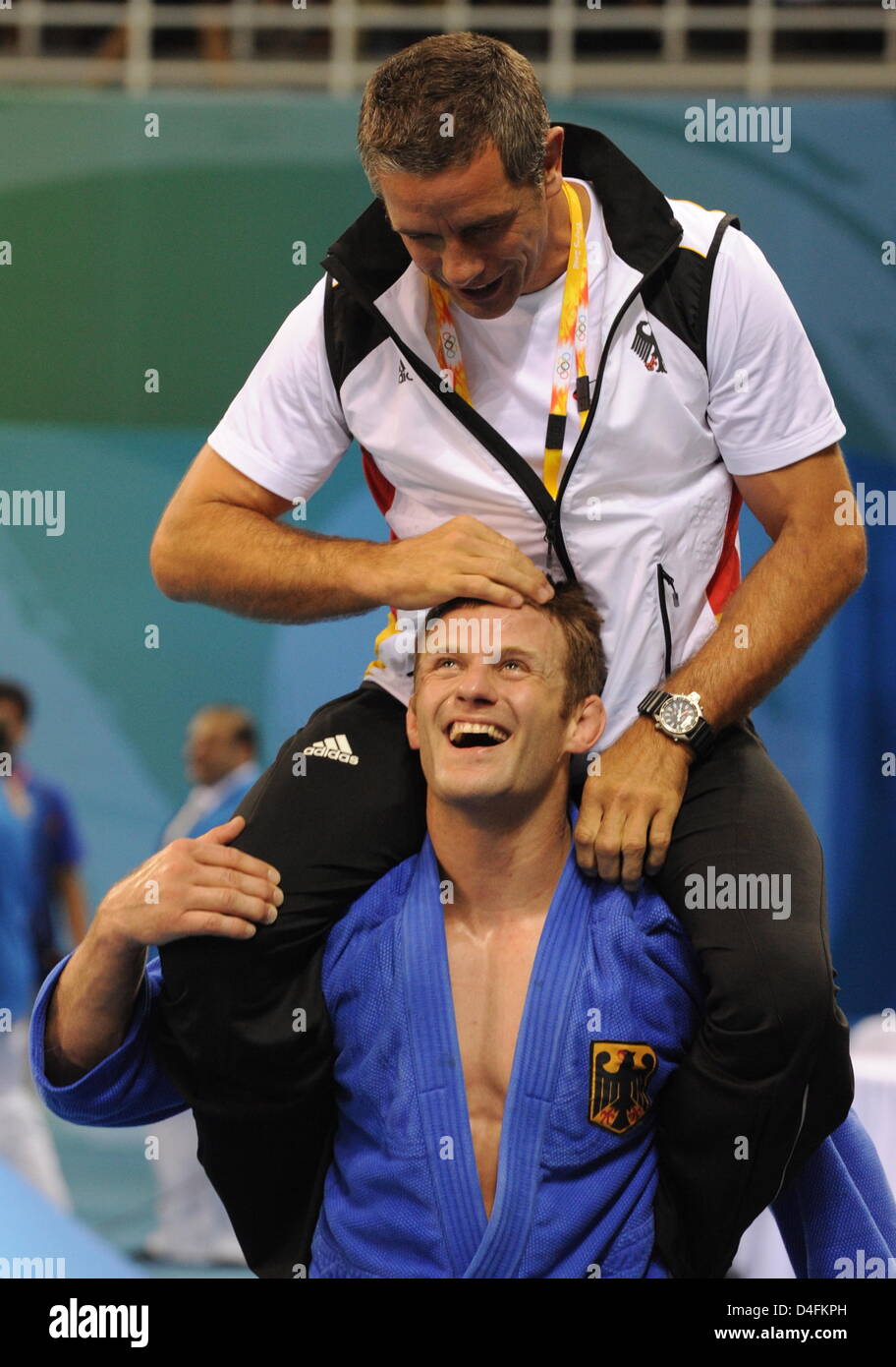 Ole Bischof from Germany lifts German head coach Frank Wieneke ...