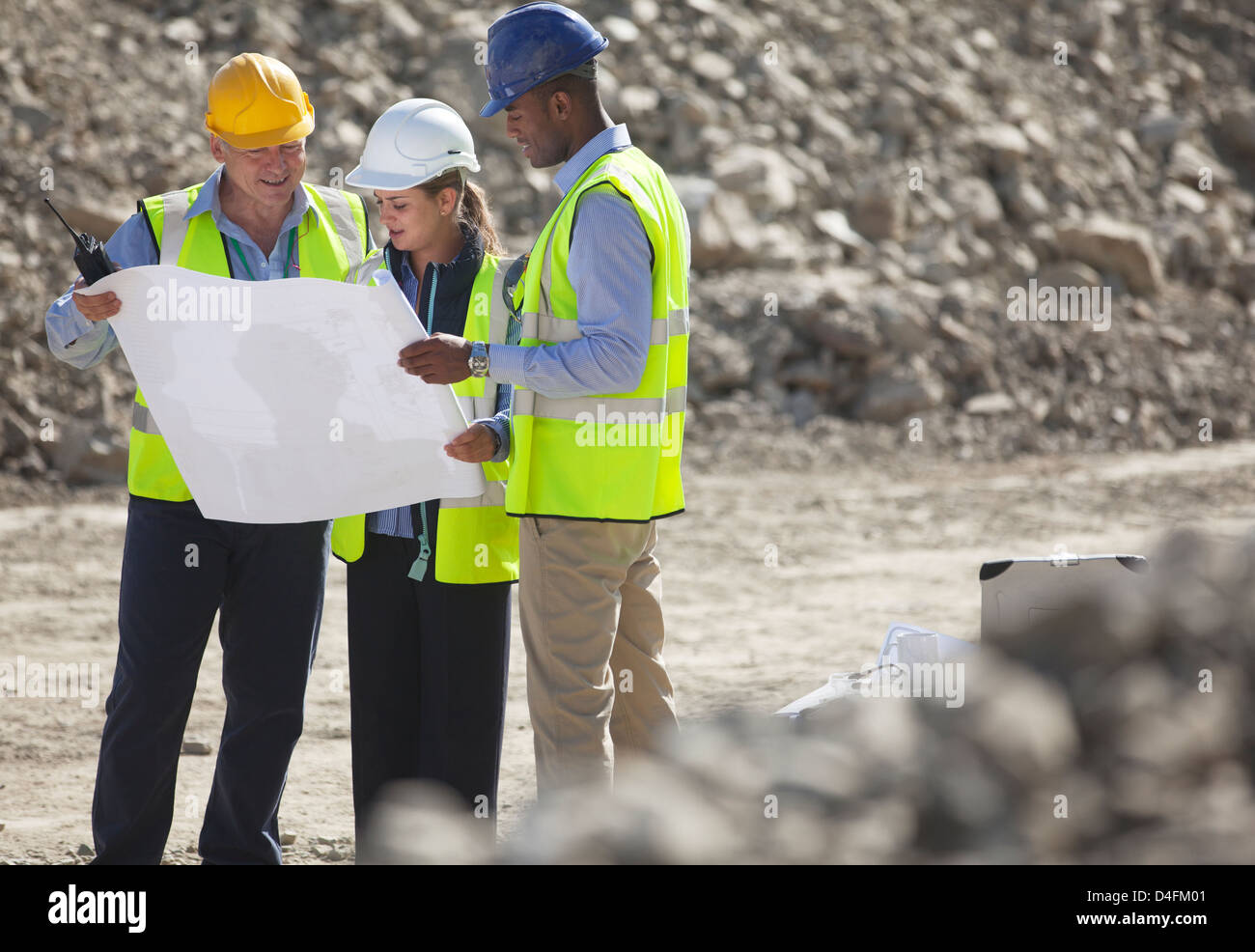 Business people reading blueprints in quarry Stock Photo - Alamy