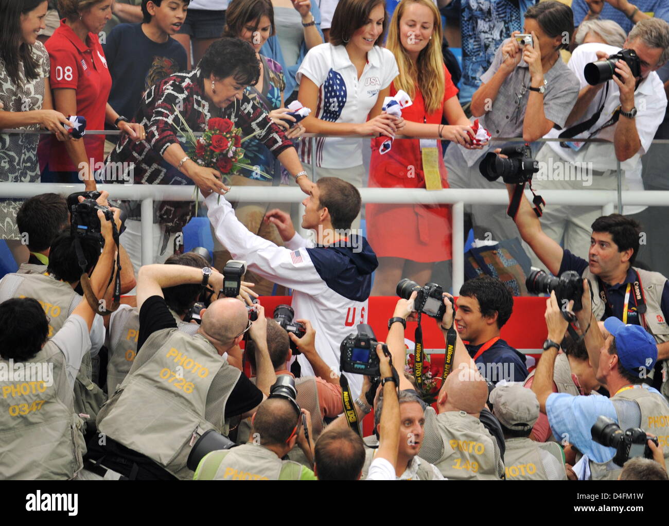 US swimmer Michael Phleps (C) celebrates with his mother Deborah ...