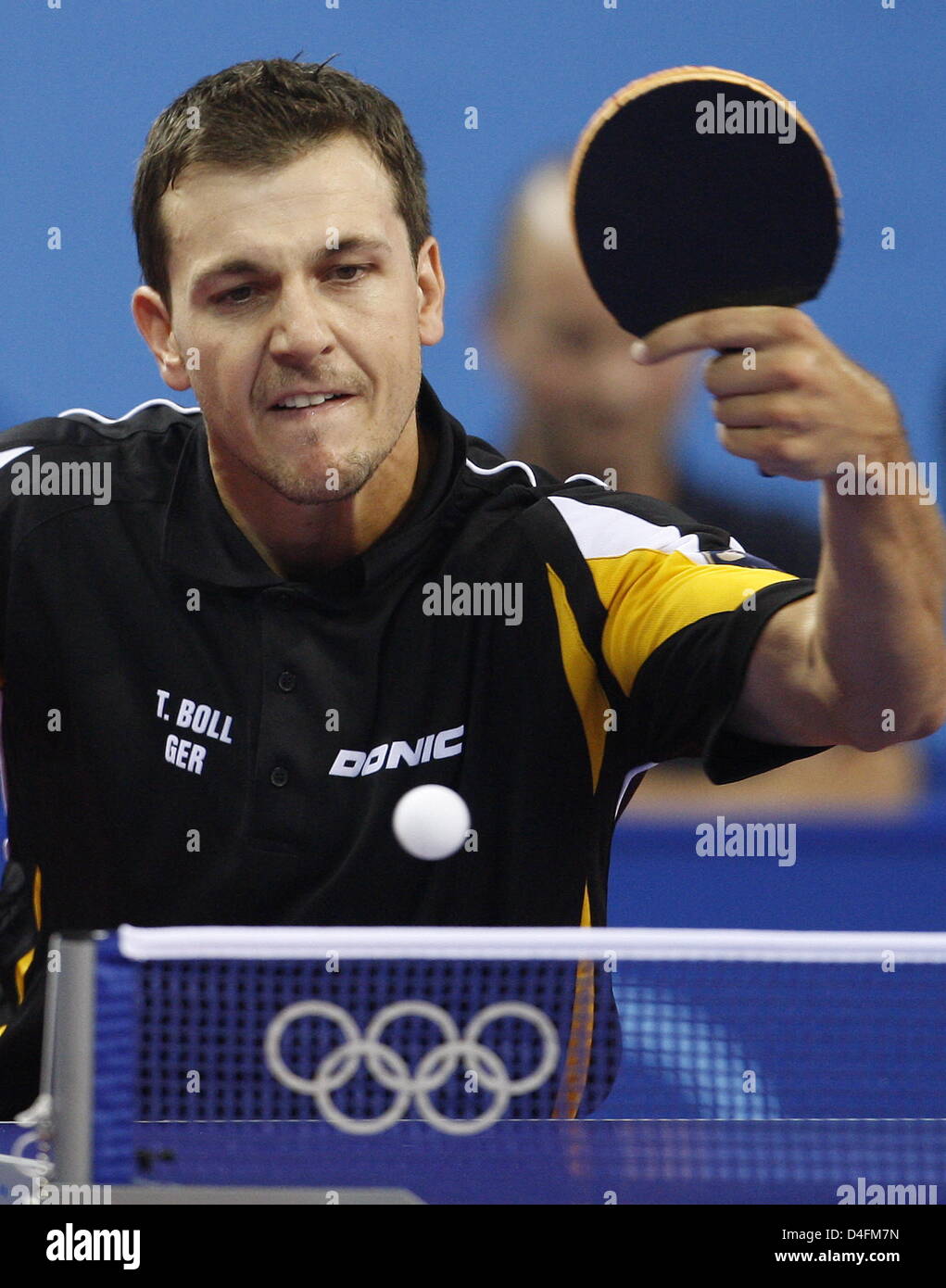 Timo Boll hits the ball during the menÒs team table tennis preliminary ...
