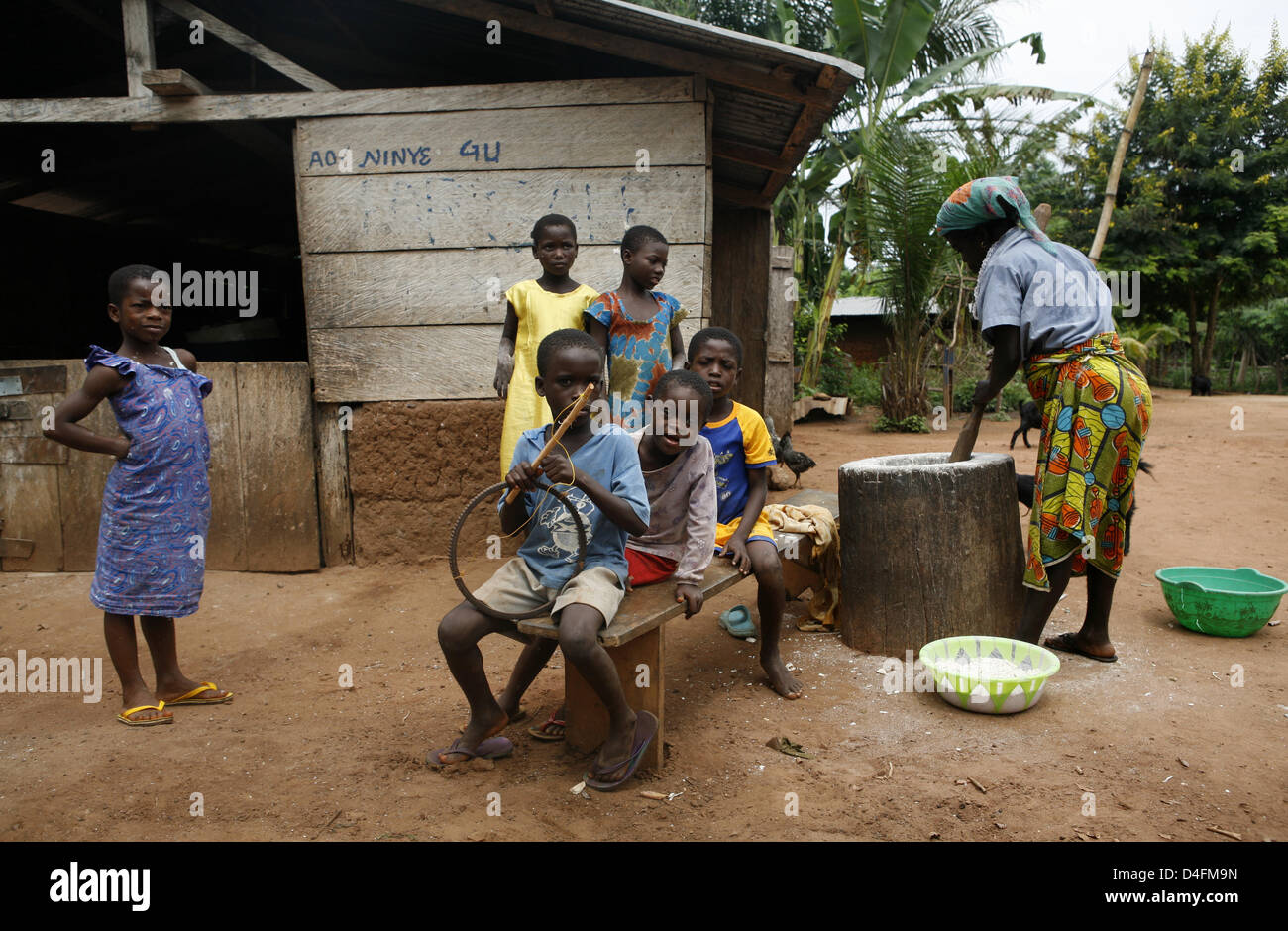 A Ghanaian family is pictured in front of their house in Apimsu, Ghana ...