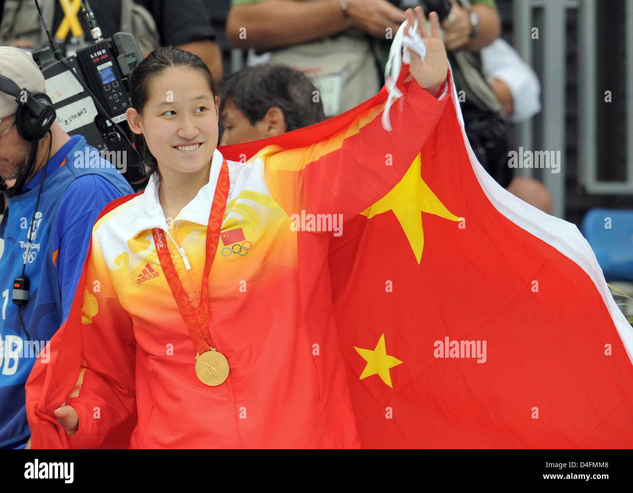 Liu Zige of China shows her gold medal after the women's 200m butterfly ...