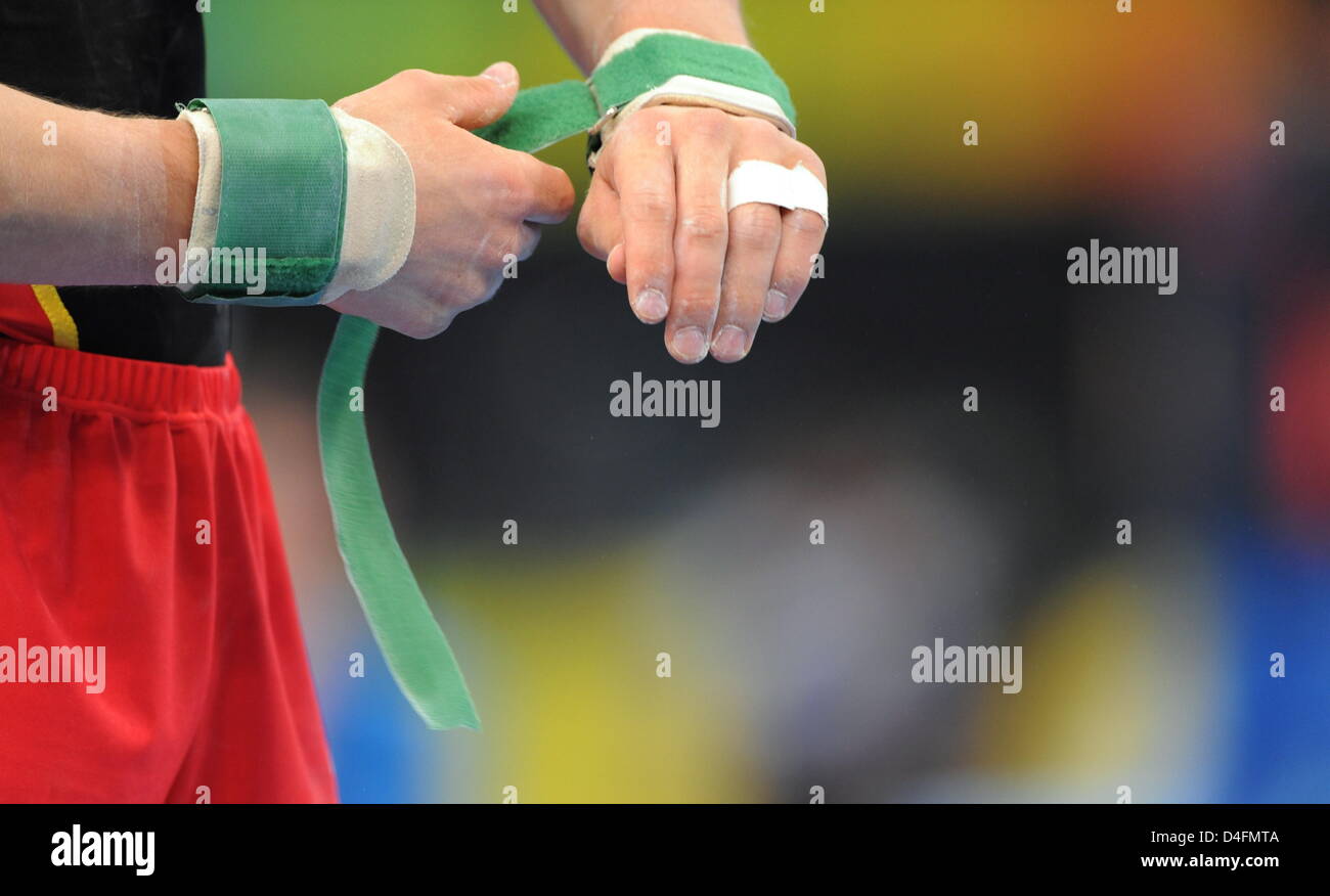 German athlete Fabian Hambuechen prepares his injured left hand prior ...