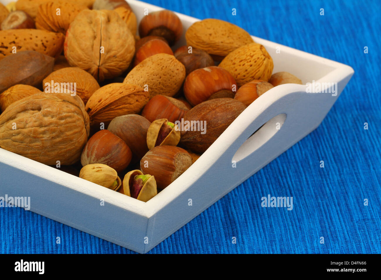 Mixed nuts on wooden tray Stock Photo - Alamy