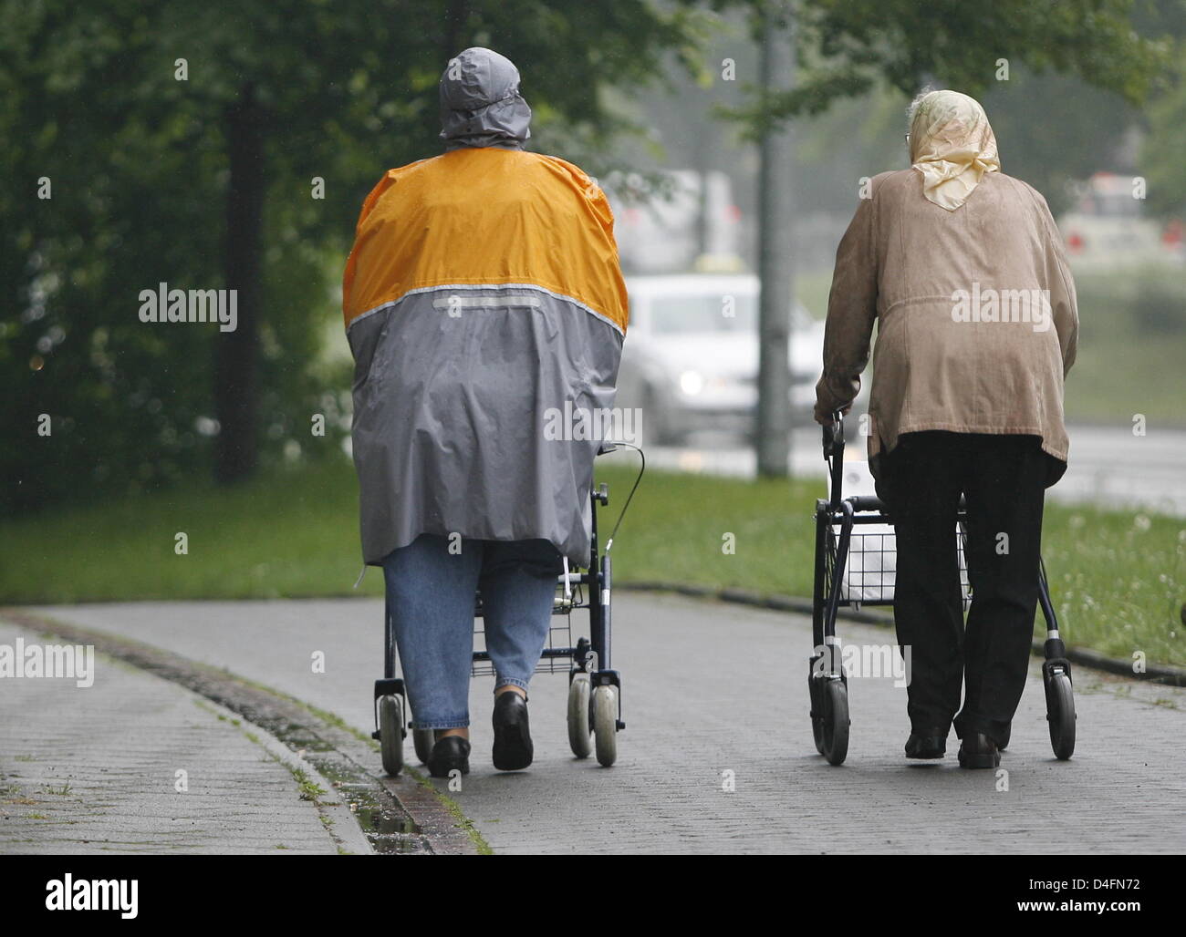 Two elderly women go for a stroll with their walking frames in the ...