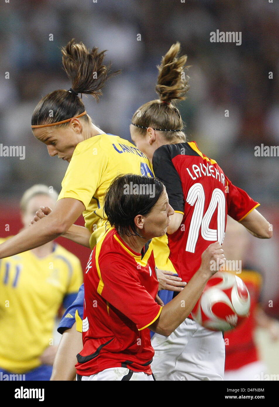 Simone Laudehr (R) and Linda Bresonik (C) of Germany vies with Jessica ...