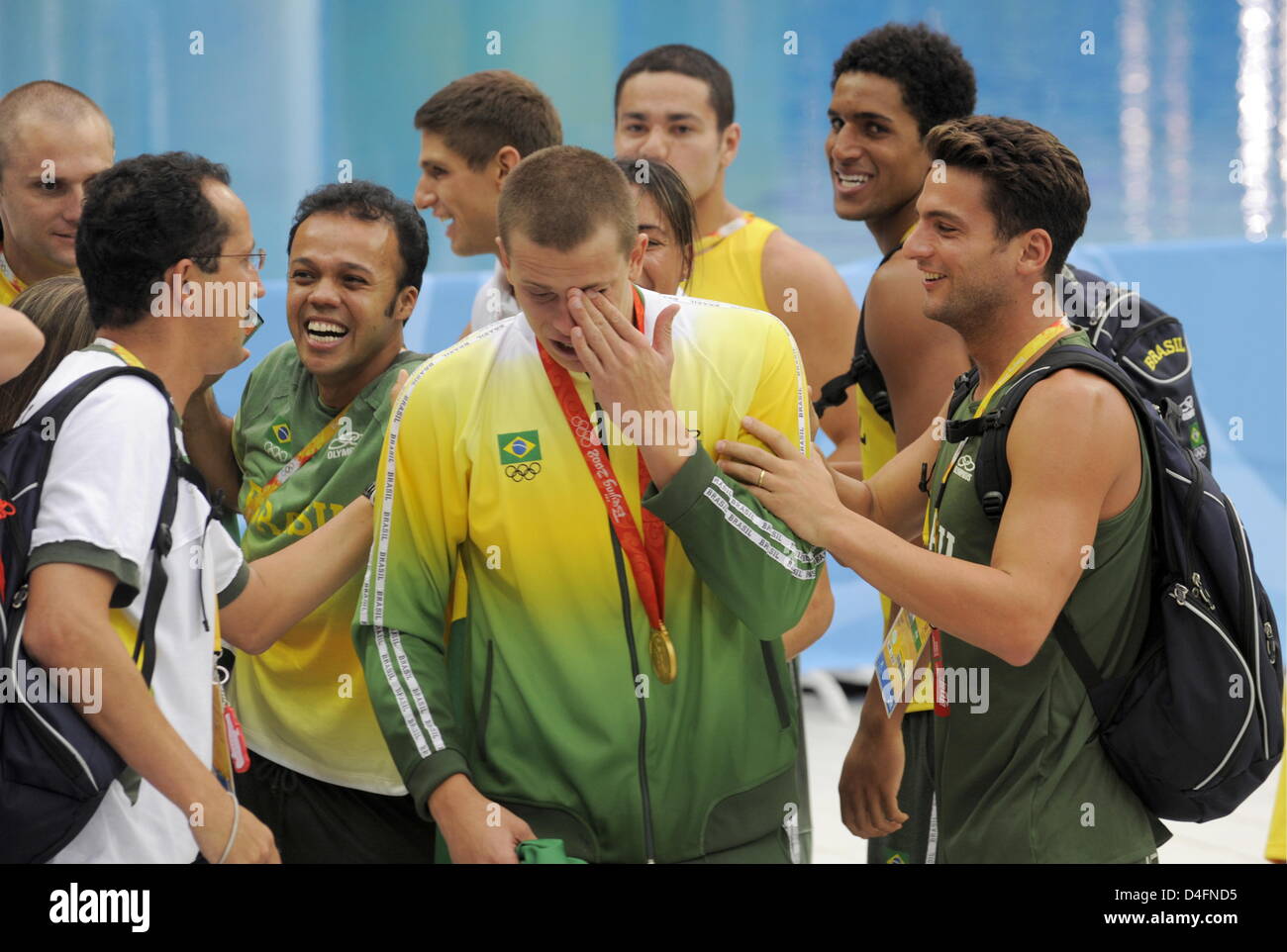Crying gold winner Cesar Cielo Filho from Brazil gets congratulations ...