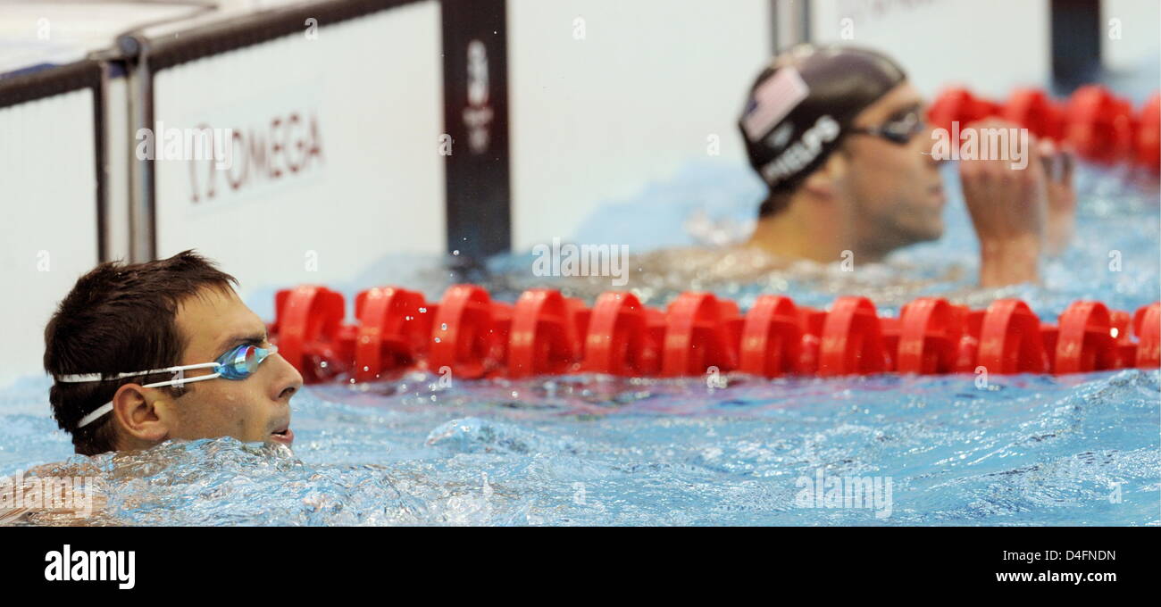Michael Phelps (R) from the USA looks at the scoreboard next to Milorad ...