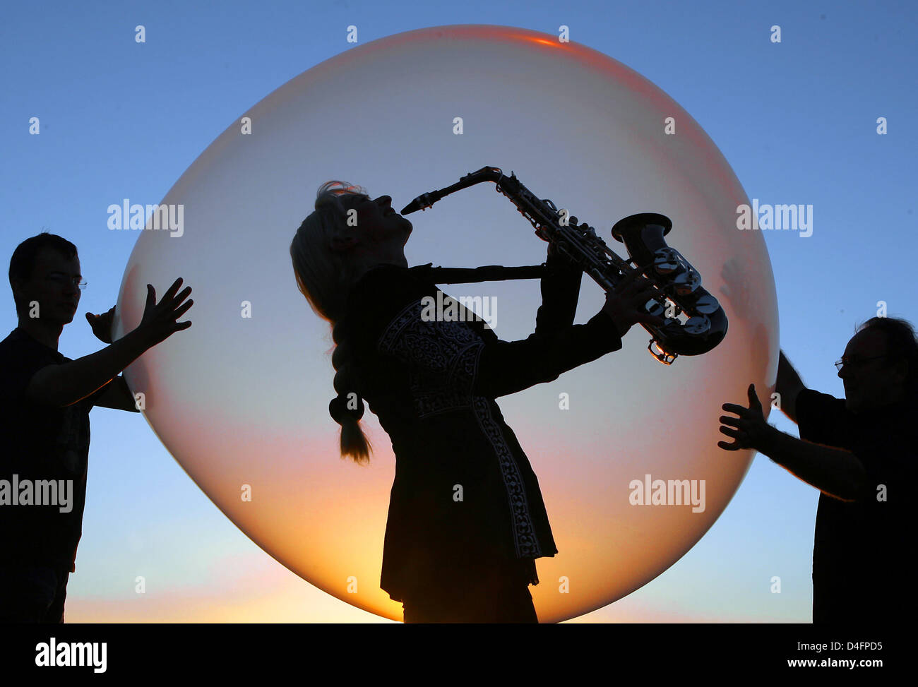 The photo shows solo saxophonist Kathrin Eipert (C), her husband and a ...