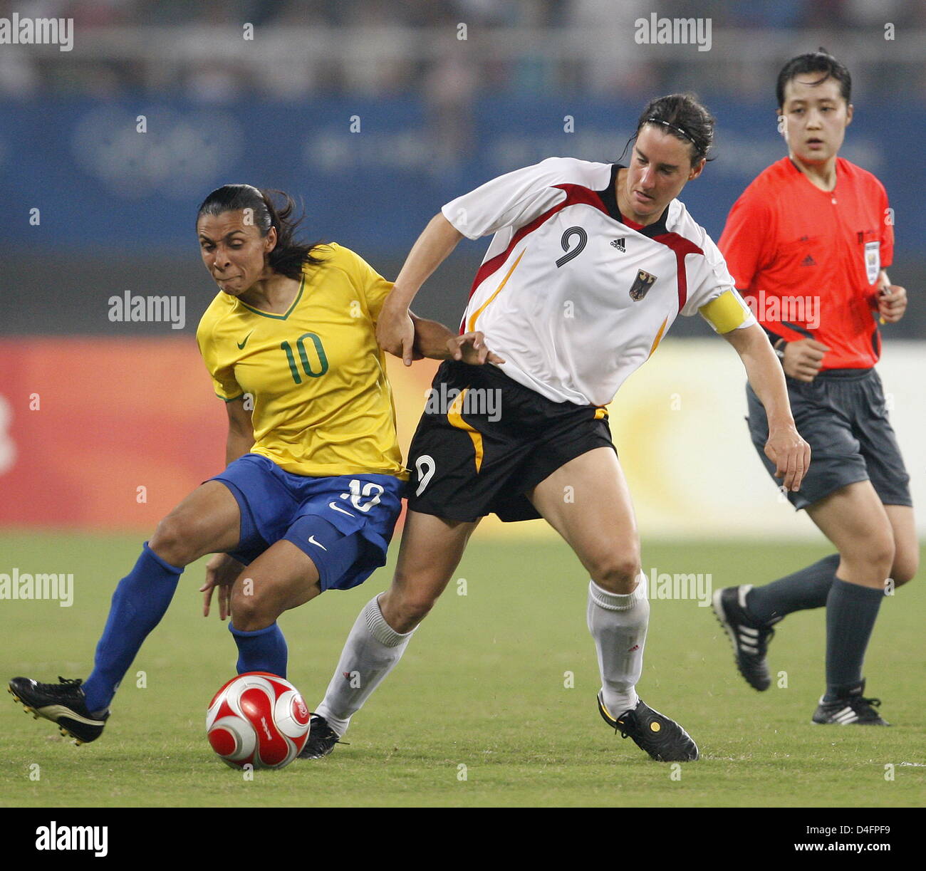 Birgit Prinz (C) of Germany vies with Marta of Brazil during the women ...