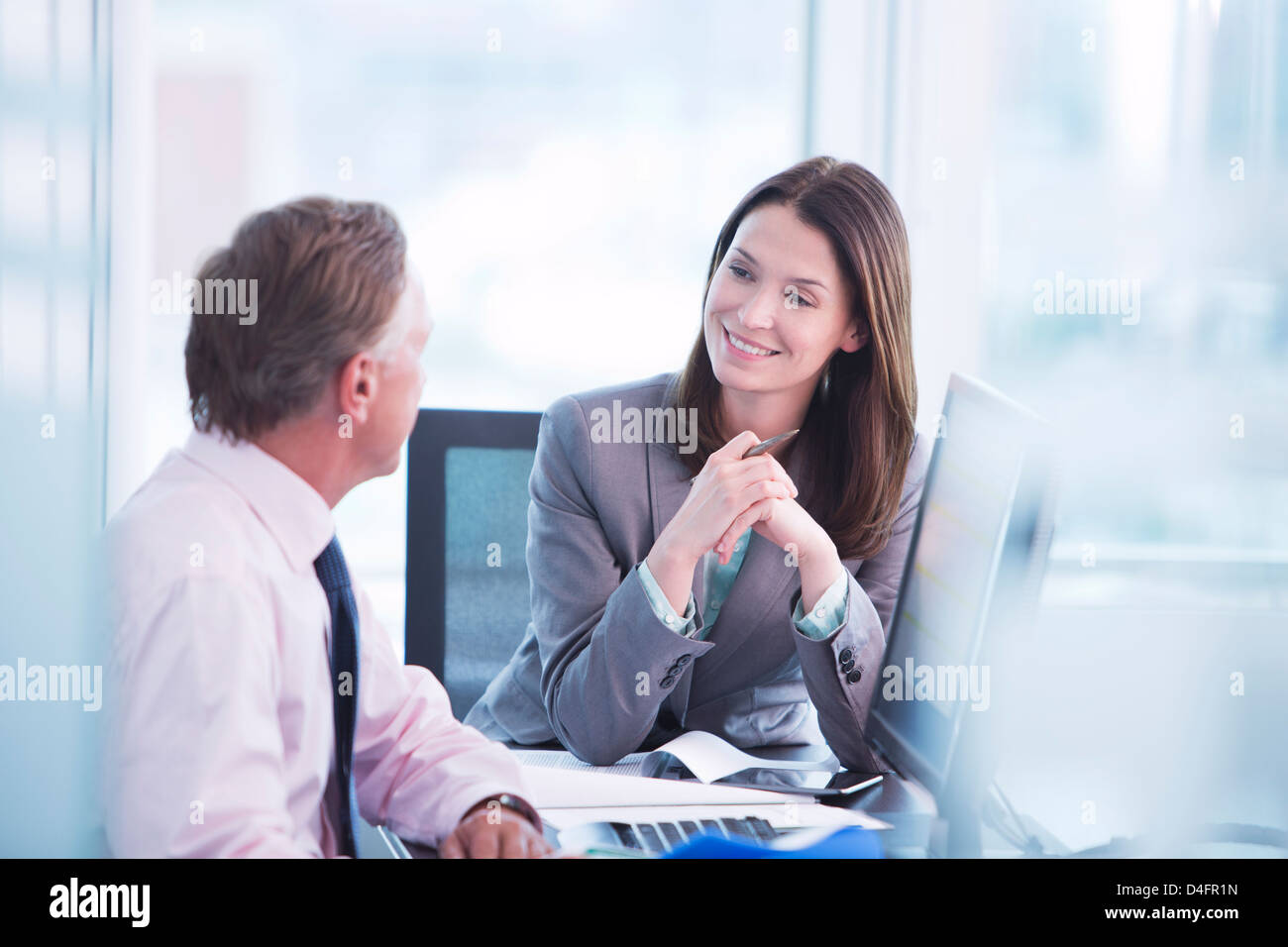 Business people talking at desk Stock Photo - Alamy