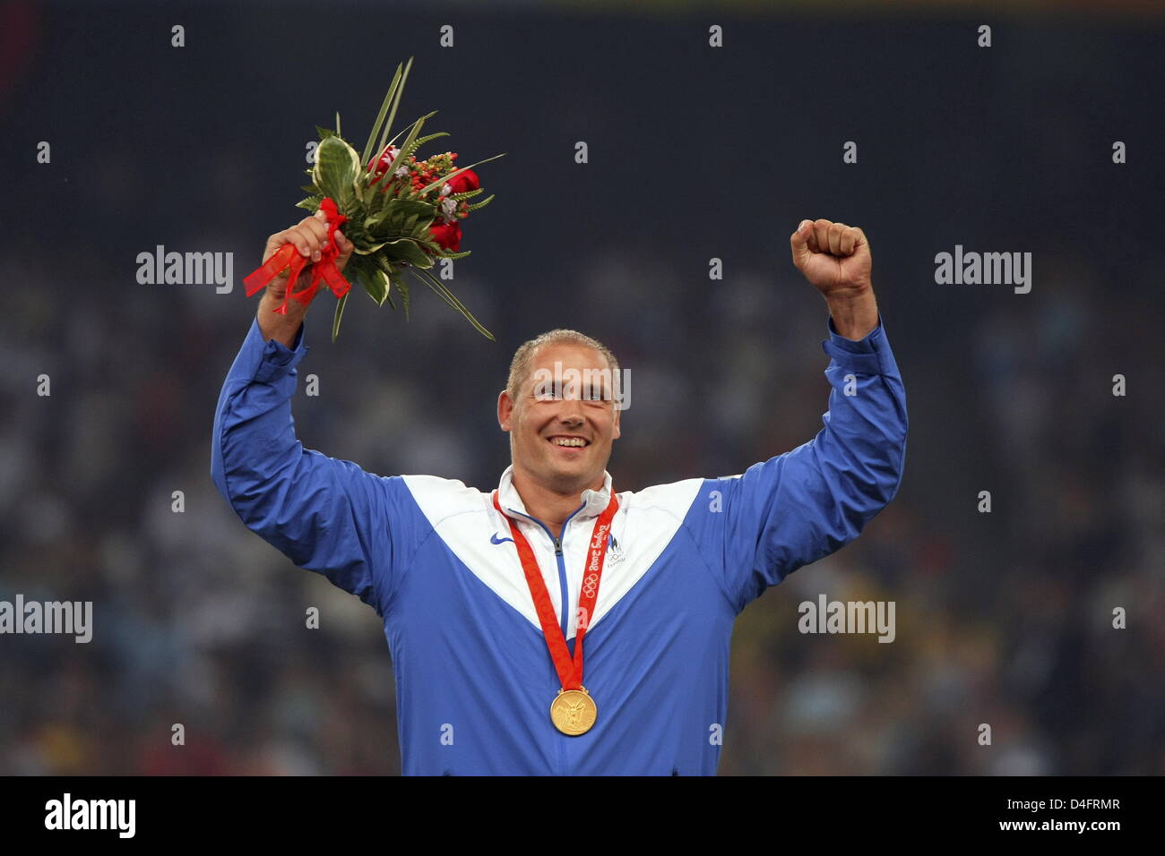 Gold medalist Gerd Kanter of Estonia celebrates on the podium during ...