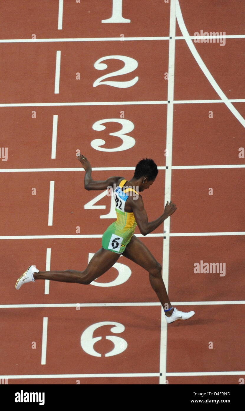 Melaine Walker of Jamaica crosses the finish line to place first in the ...