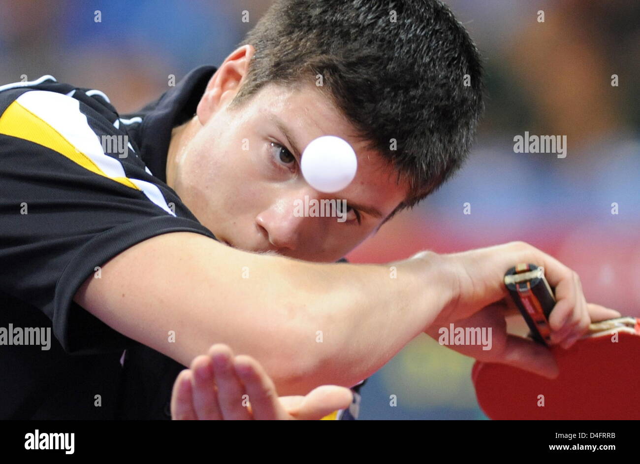 Dimitrij Ovtcharov (black) of Germany serves to Adrian Crisan Romania ...