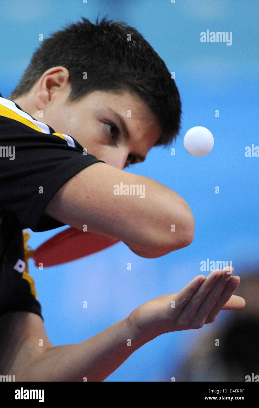 Dimitrij Ovtcharov (black) of Germany serves to Adrian Crisan Romania ...