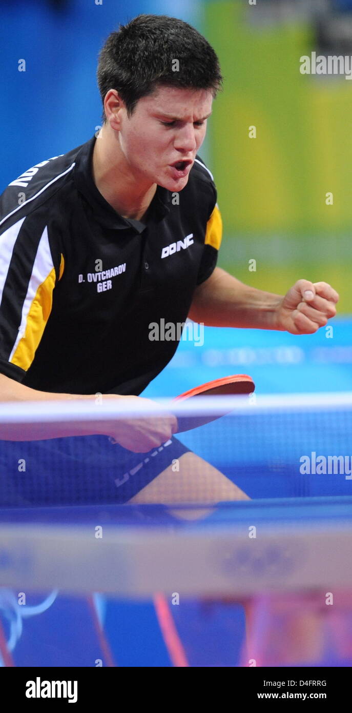 Dimitrij Ovtcharov (black) of Germany reacts with clenched fist to ...
