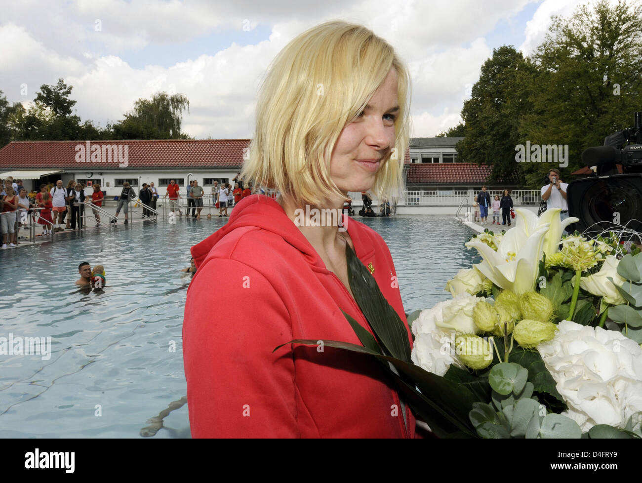 Double Olympic gold medalist Britta Steffen is received with a bouqet ...